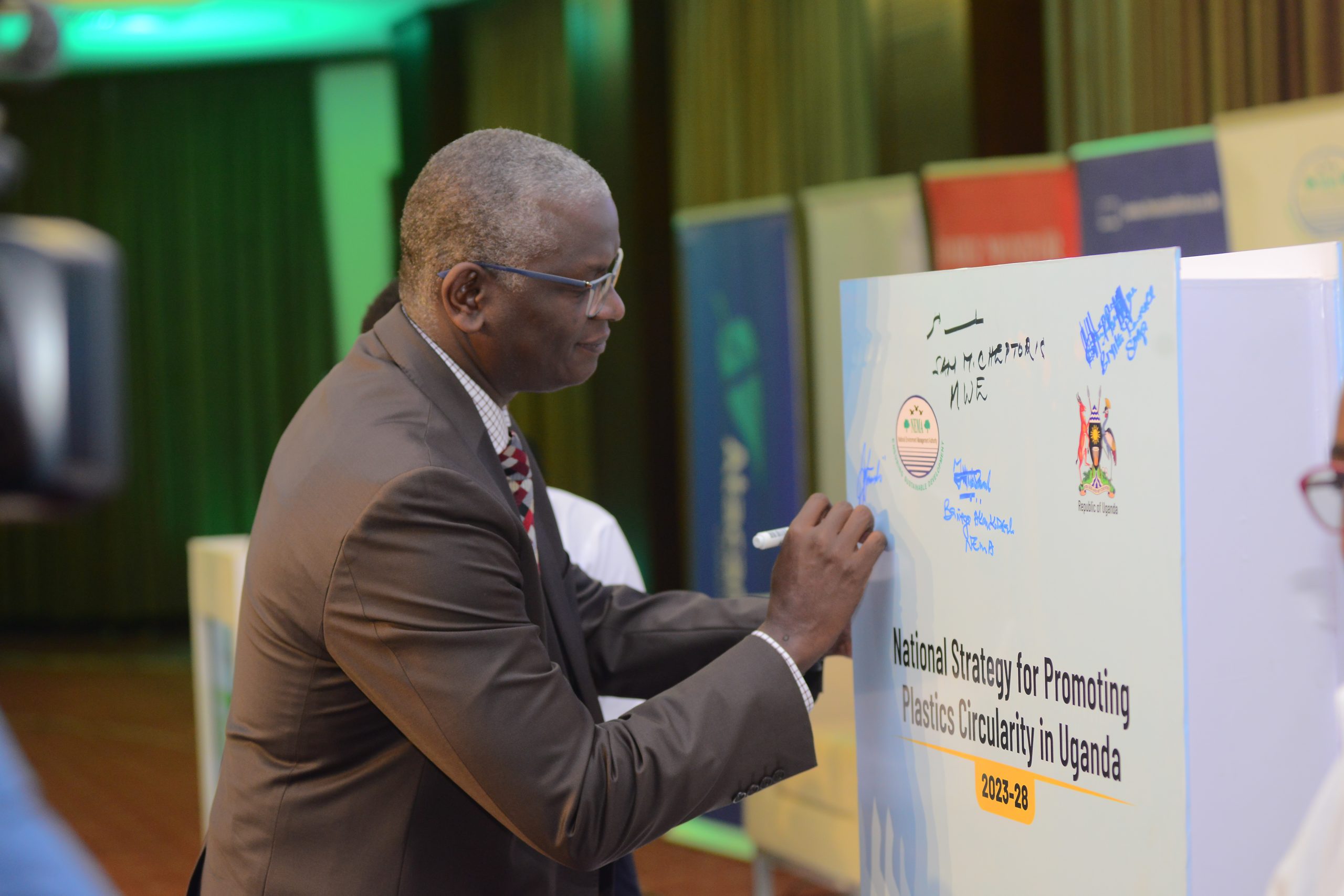 The UBL Managing Director Andrew Kilonzo, signs during the launch of ...
